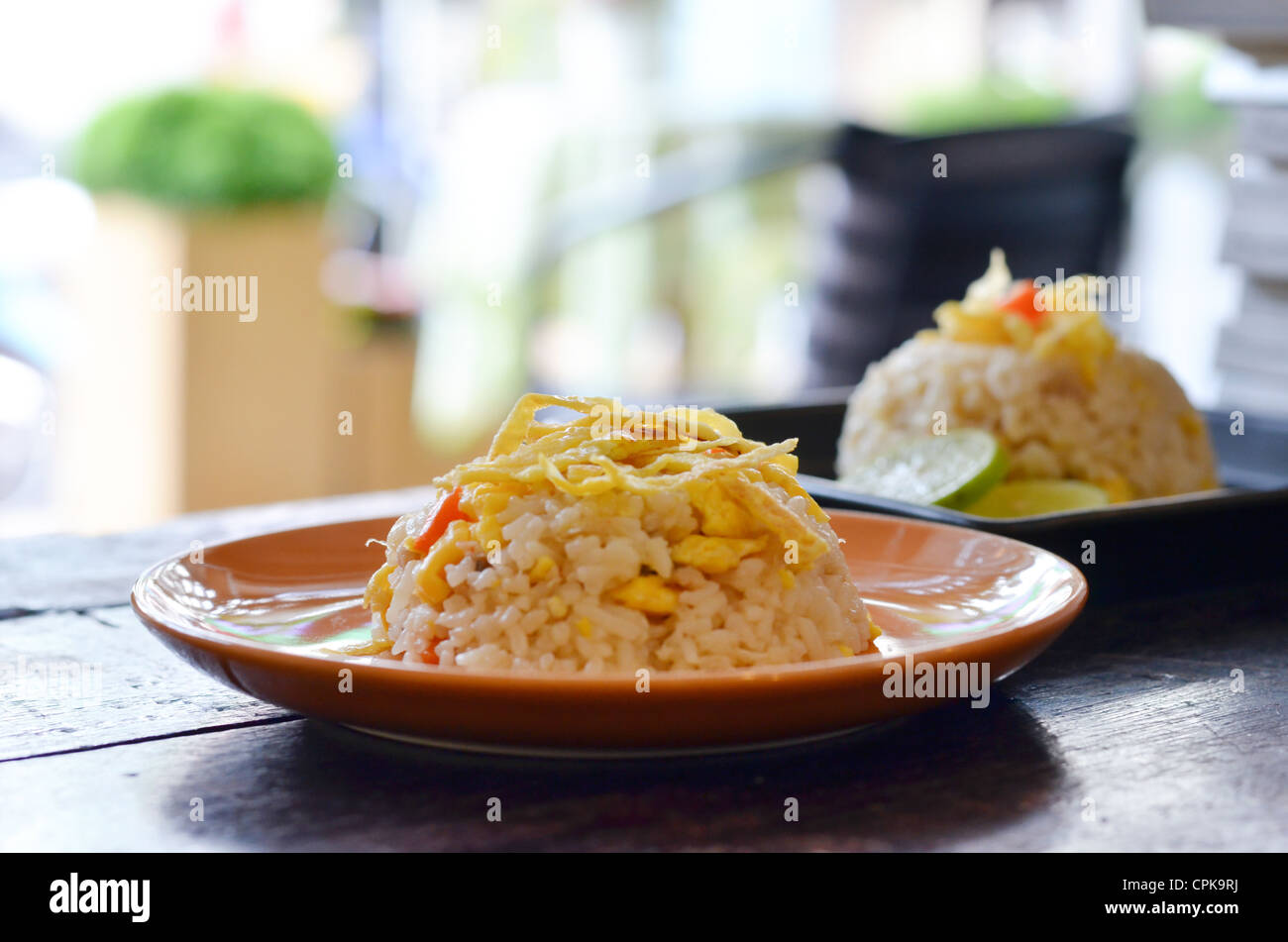 two dish of delicious fried rice on wood table Stock Photo - Alamy