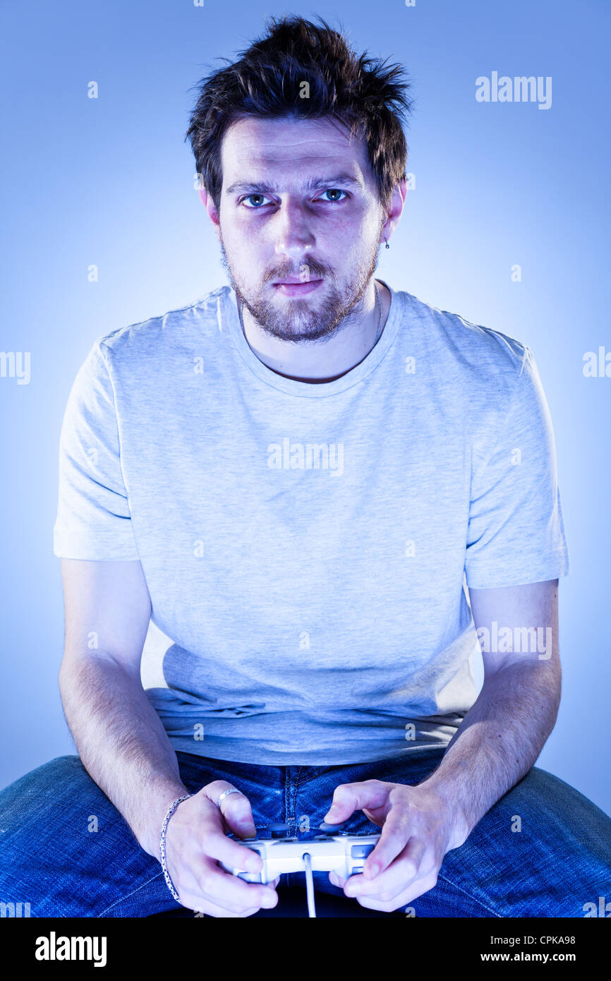 Serious Man Playing Videogames with Gamepad Stock Photo - Alamy