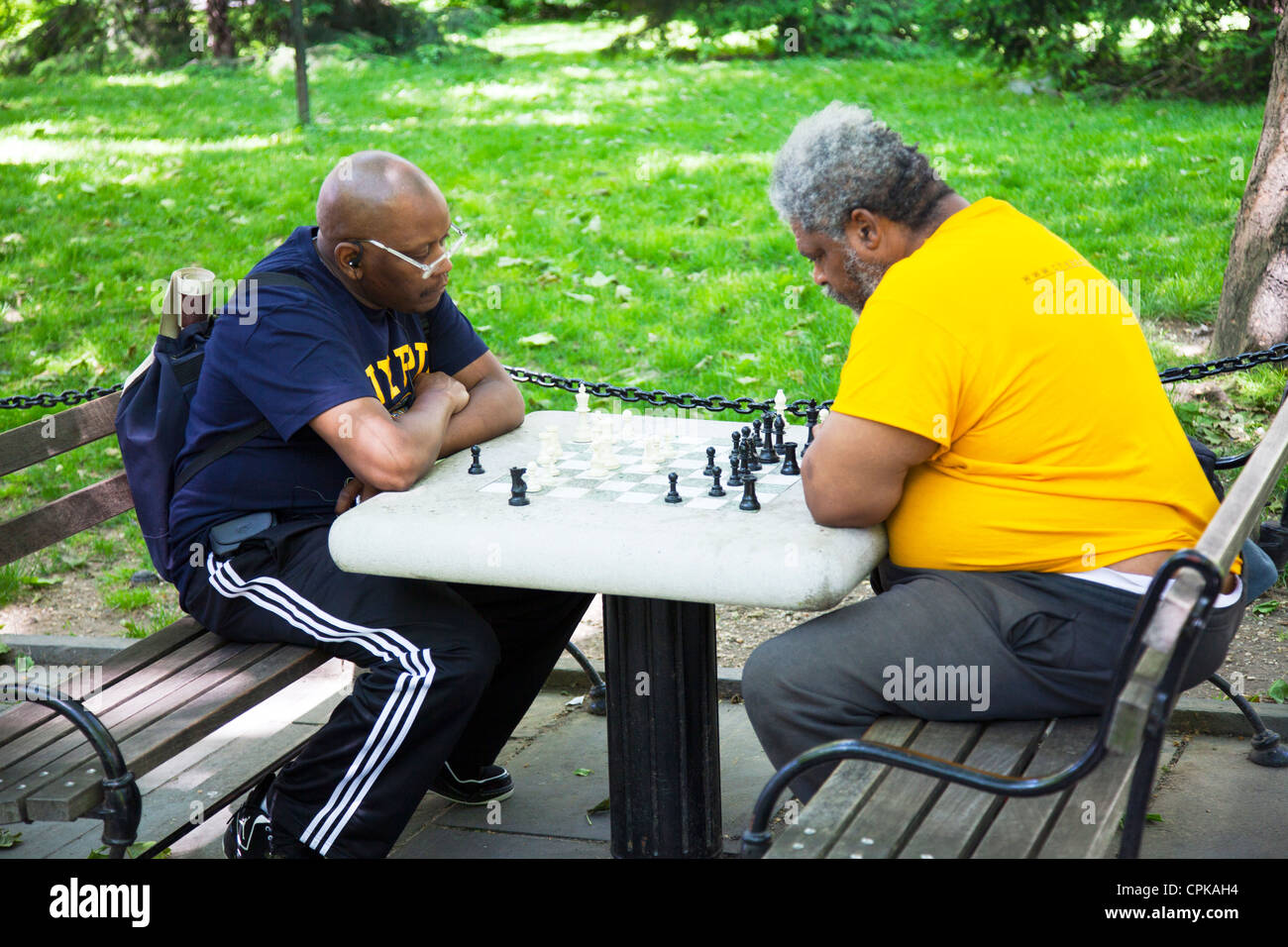 Men playing chess game in park in New York in Steve Flanders Square in ...