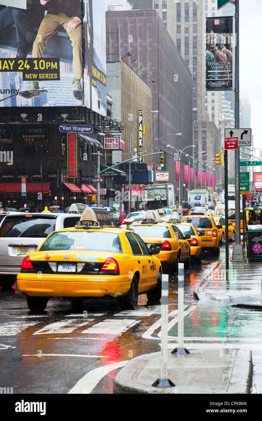 Iconic yellow taxis of New York lined up in traffic, typical transport ...