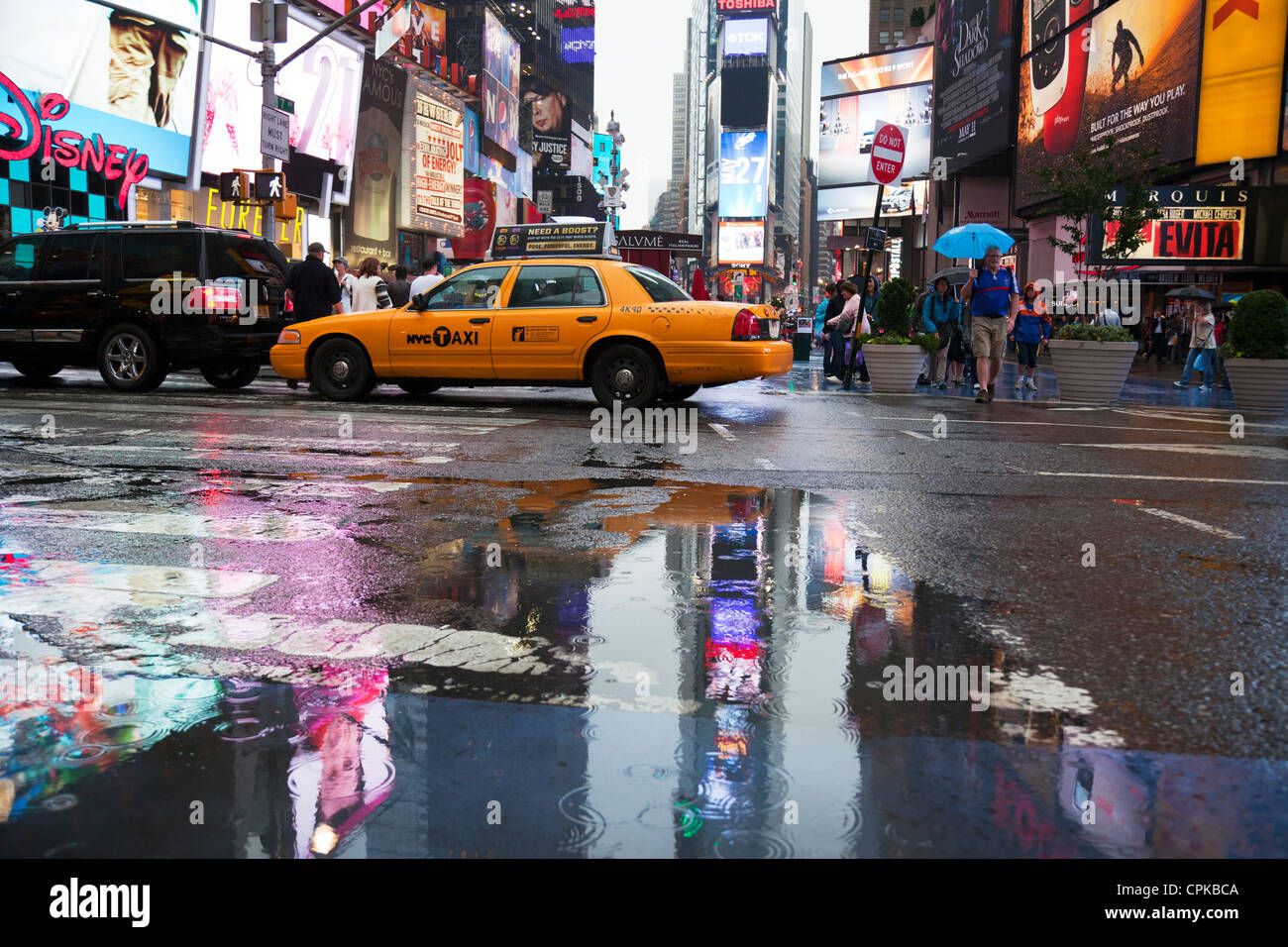 Iconic New York yellow taxis in Times Square, Manhattan. Reflections ...