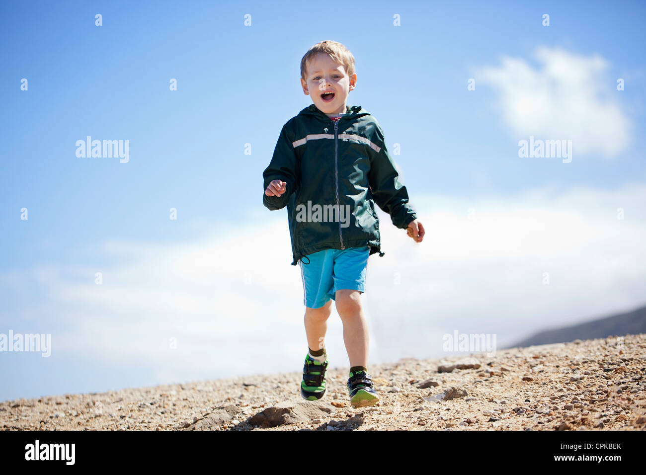 Young boy running with enthusiasm Stock Photo - Alamy