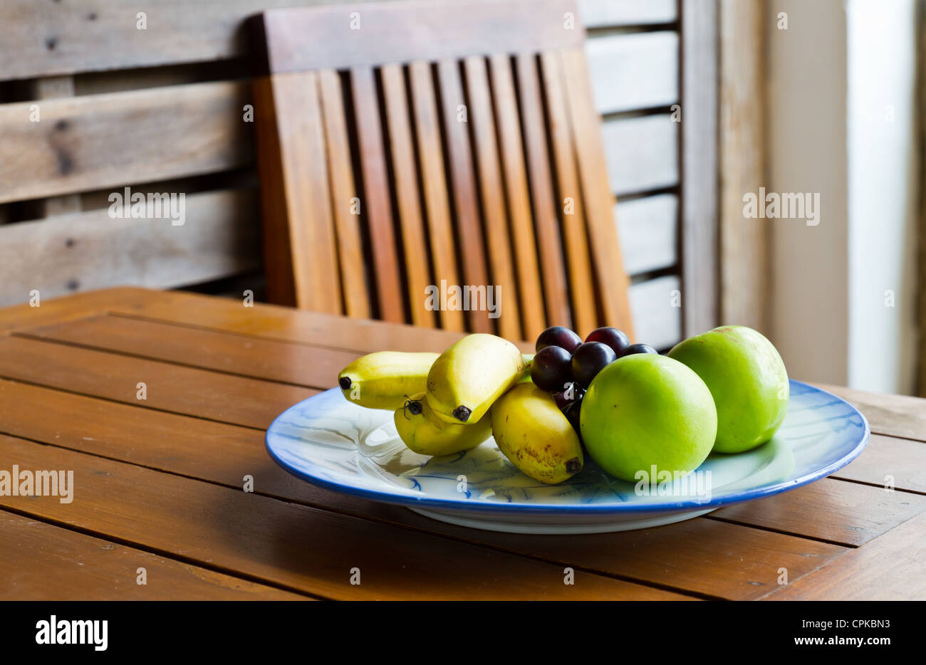 Tropical fruits on wood table Stock Photo - Alamy