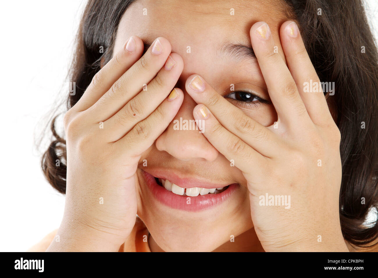 Girl hiding her face with two hands Stock Photo - Alamy