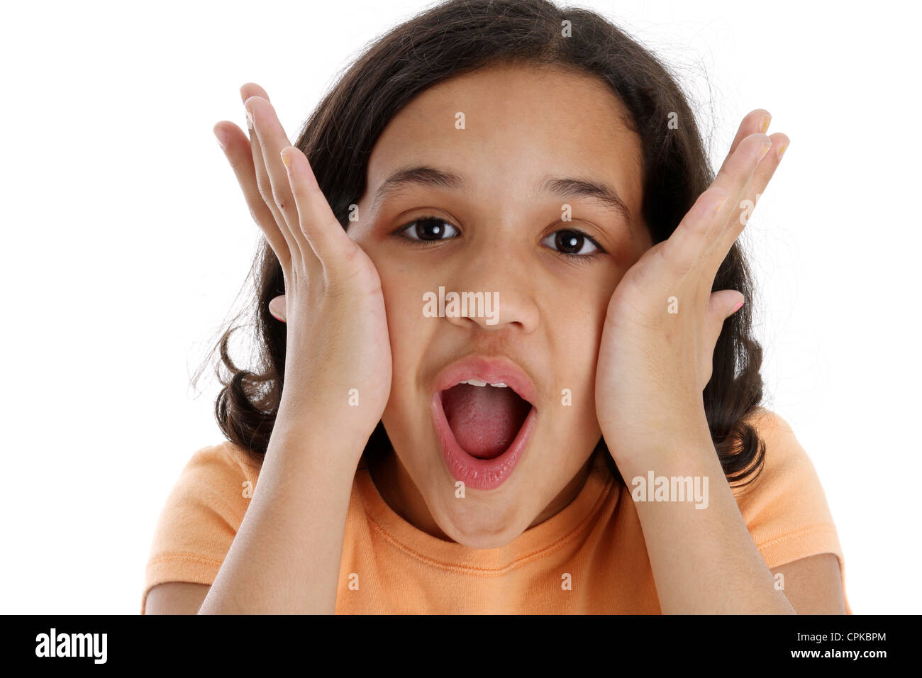 A Young girl with an excited look on white background Stock Photo - Alamy