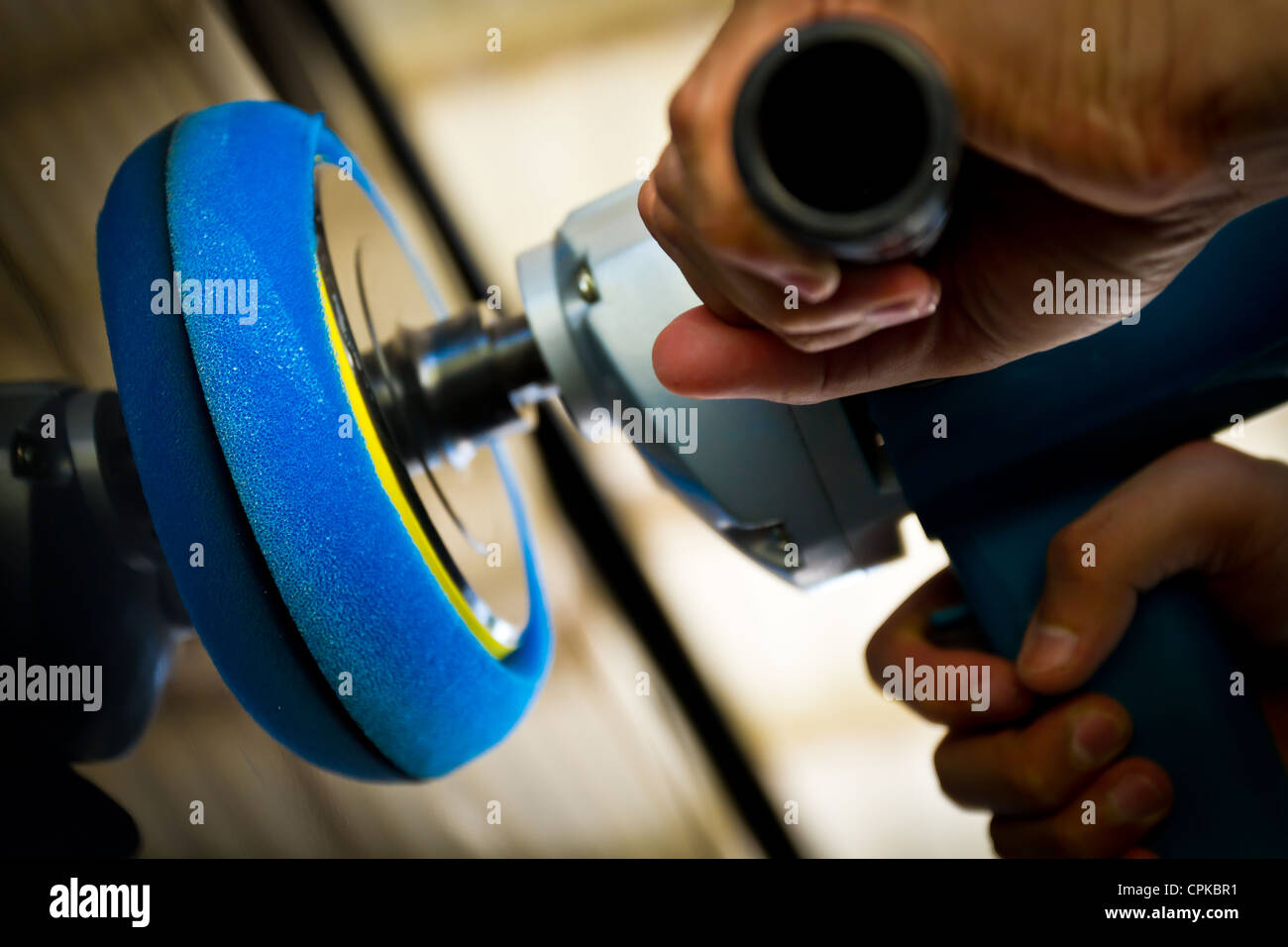 Hand holding car polisher Stock Photo - Alamy