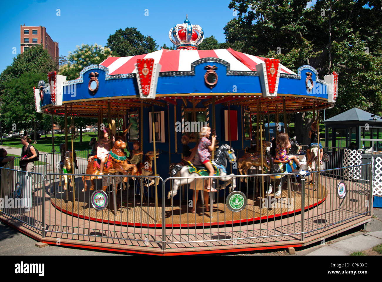 Little girls ride carousel (merry go round) on Boston Common Stock ...