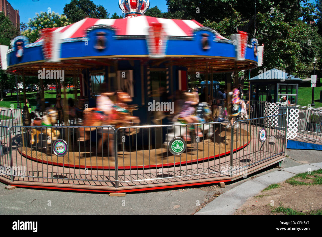 Little girls ride carousel (merry go round) on Boston Common Stock ...