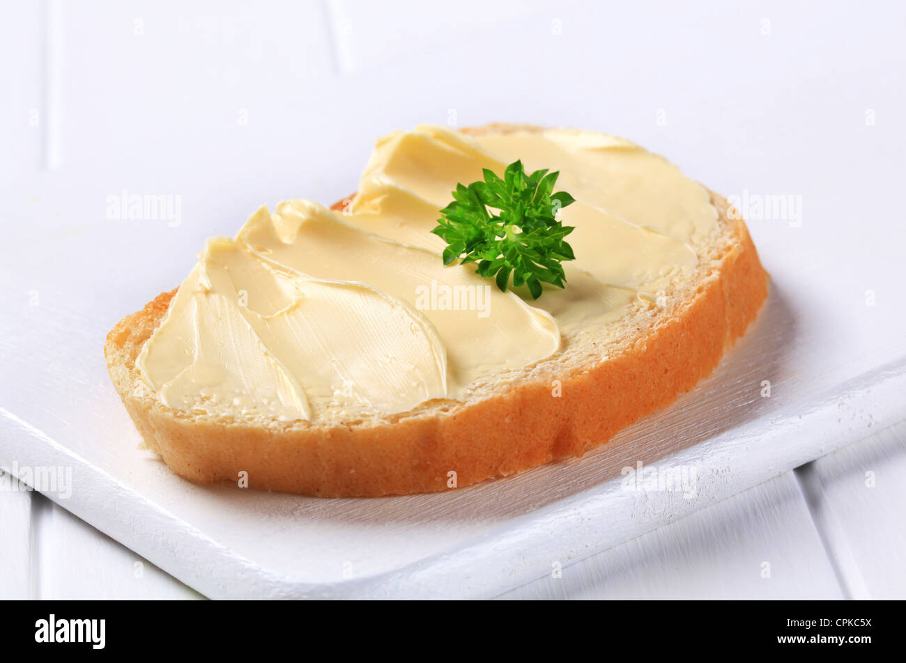 Slice of white bread with butter Stock Photo - Alamy