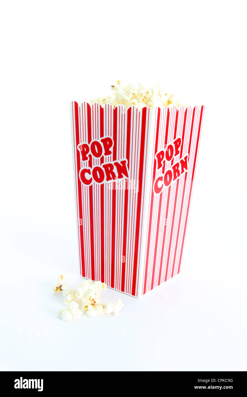 Red popcorn tub overflowing on white background Stock Photo - Alamy