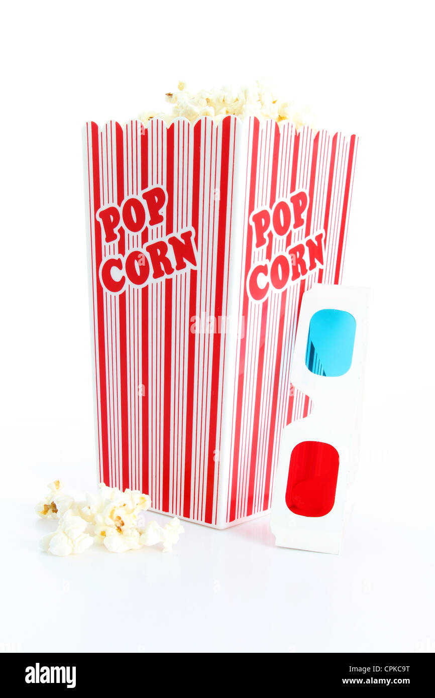 Red popcorn tub overflowing on white background Stock Photo - Alamy