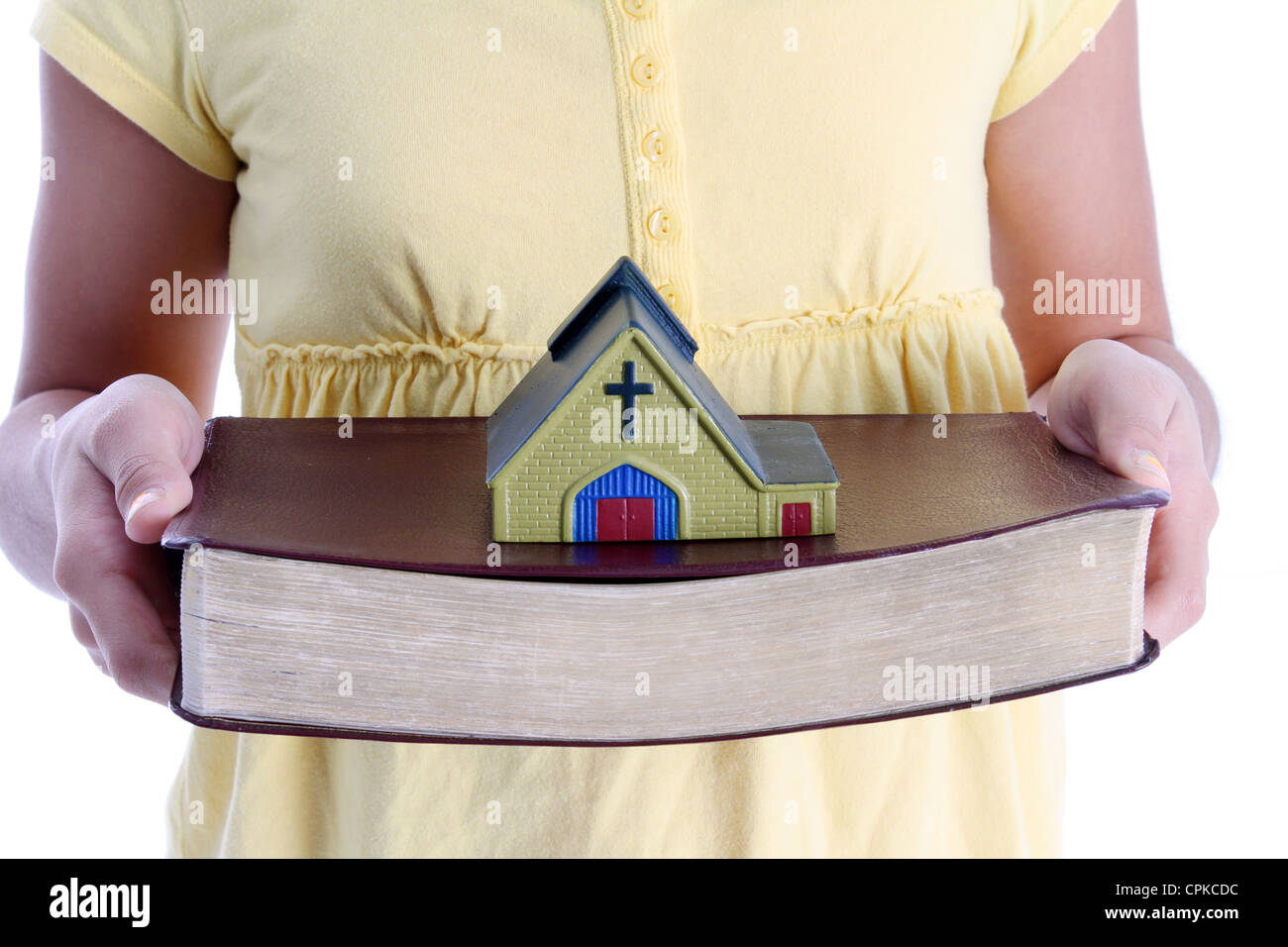 Picture of a child holding a Bible set on white background Stock Photo ...