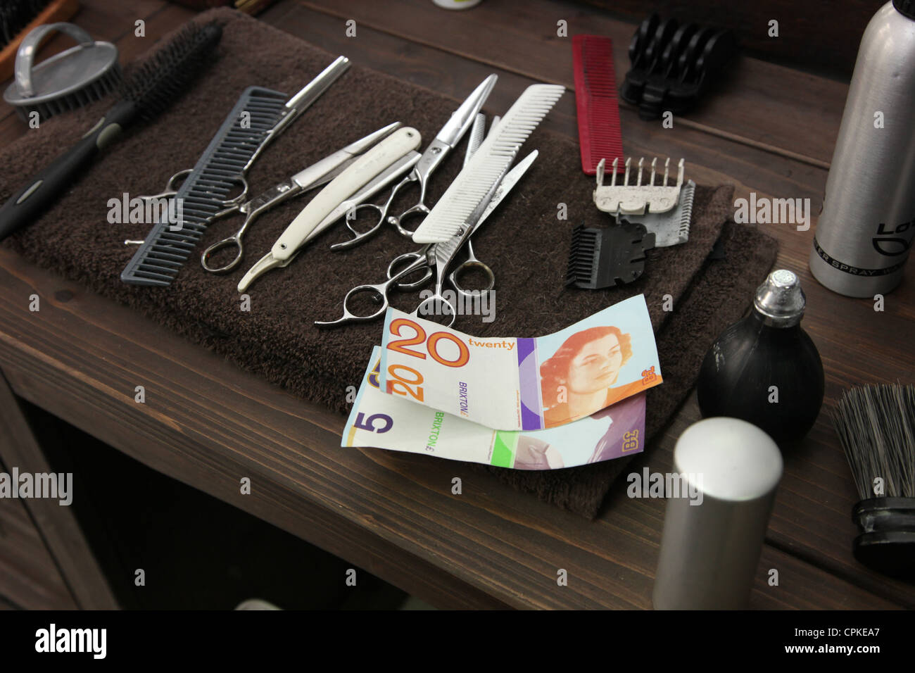 Brixton Pound notes in a barber shop. B£ is a local currency promoting ...