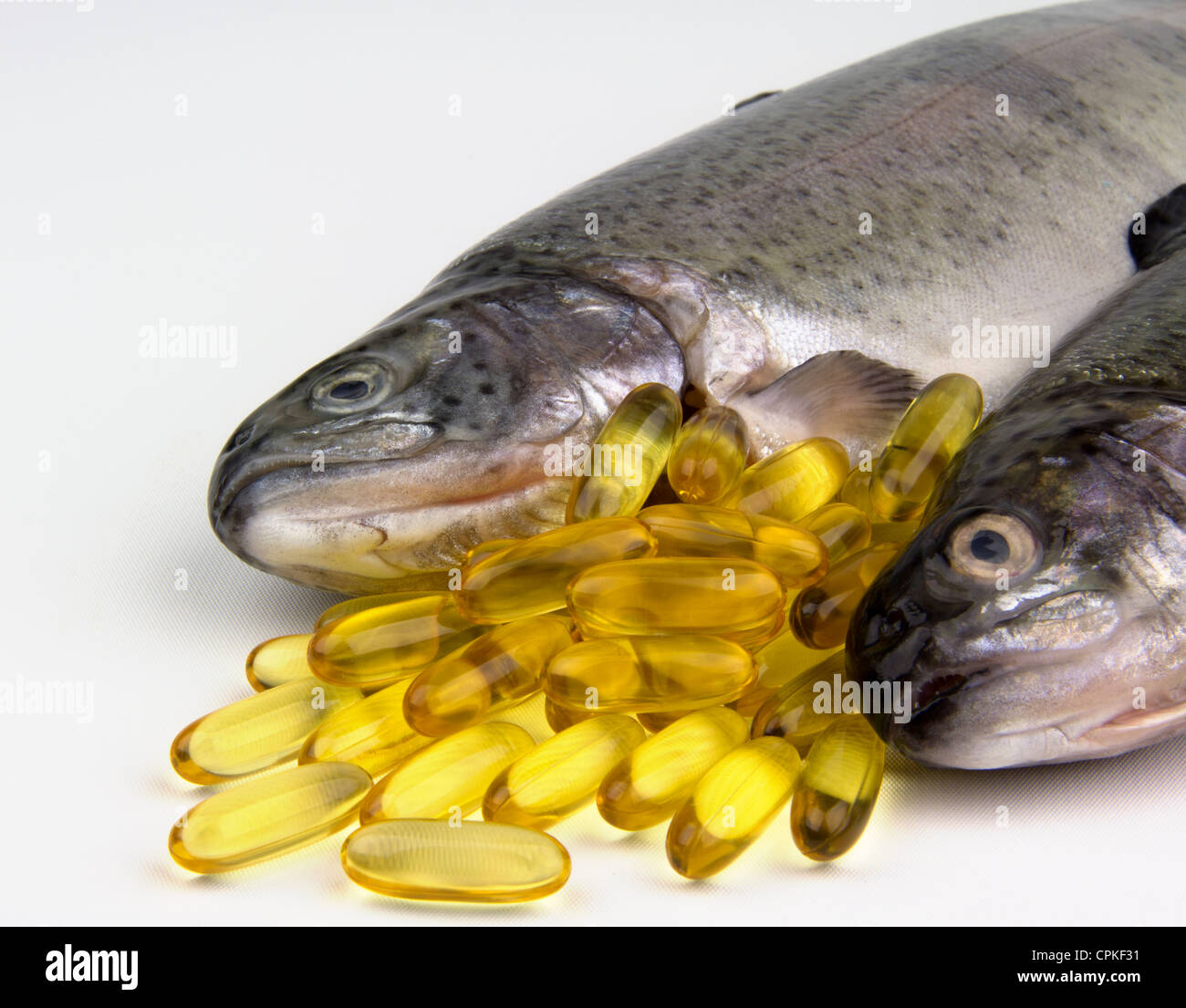 Fish oil capsules with trout next to them Stock Photo - Alamy