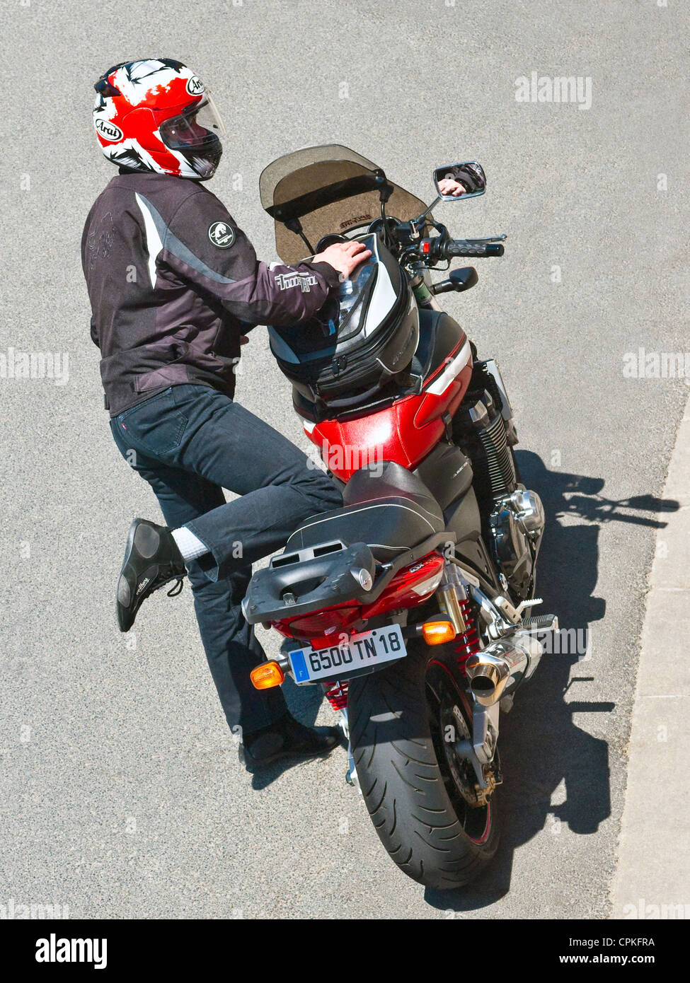 Overhead view motorcyclist mounting red motorbike - France Stock Photo ...