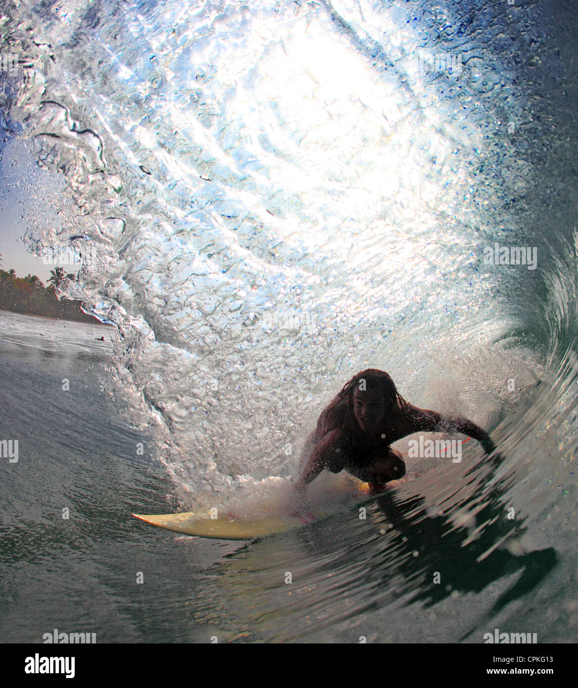 Surfer surfing inside the tube on a wave in south Sumatra Stock Photo ...