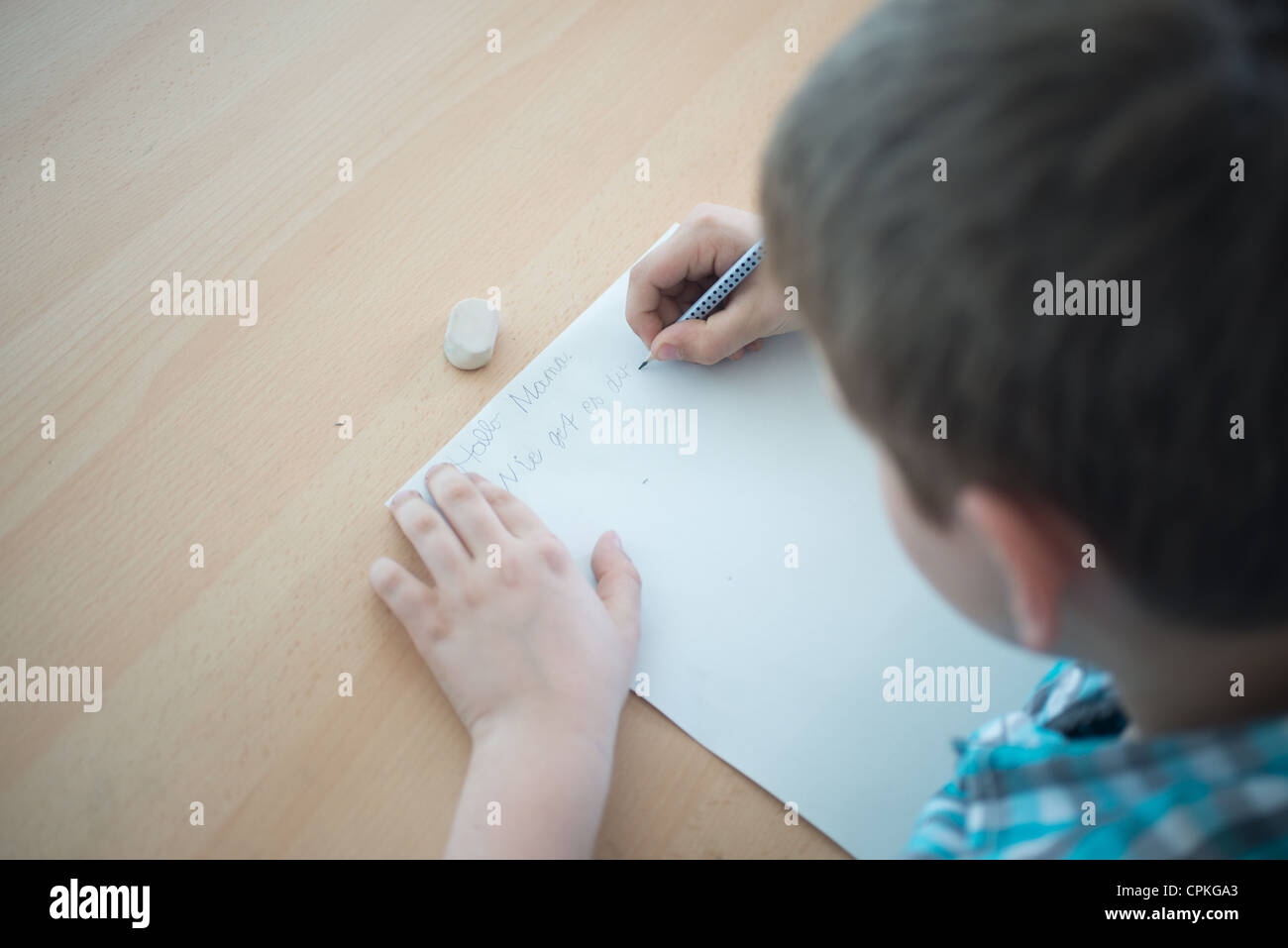 Young boy, 7 years old, writing and doing his homework Stock Photo - Alamy