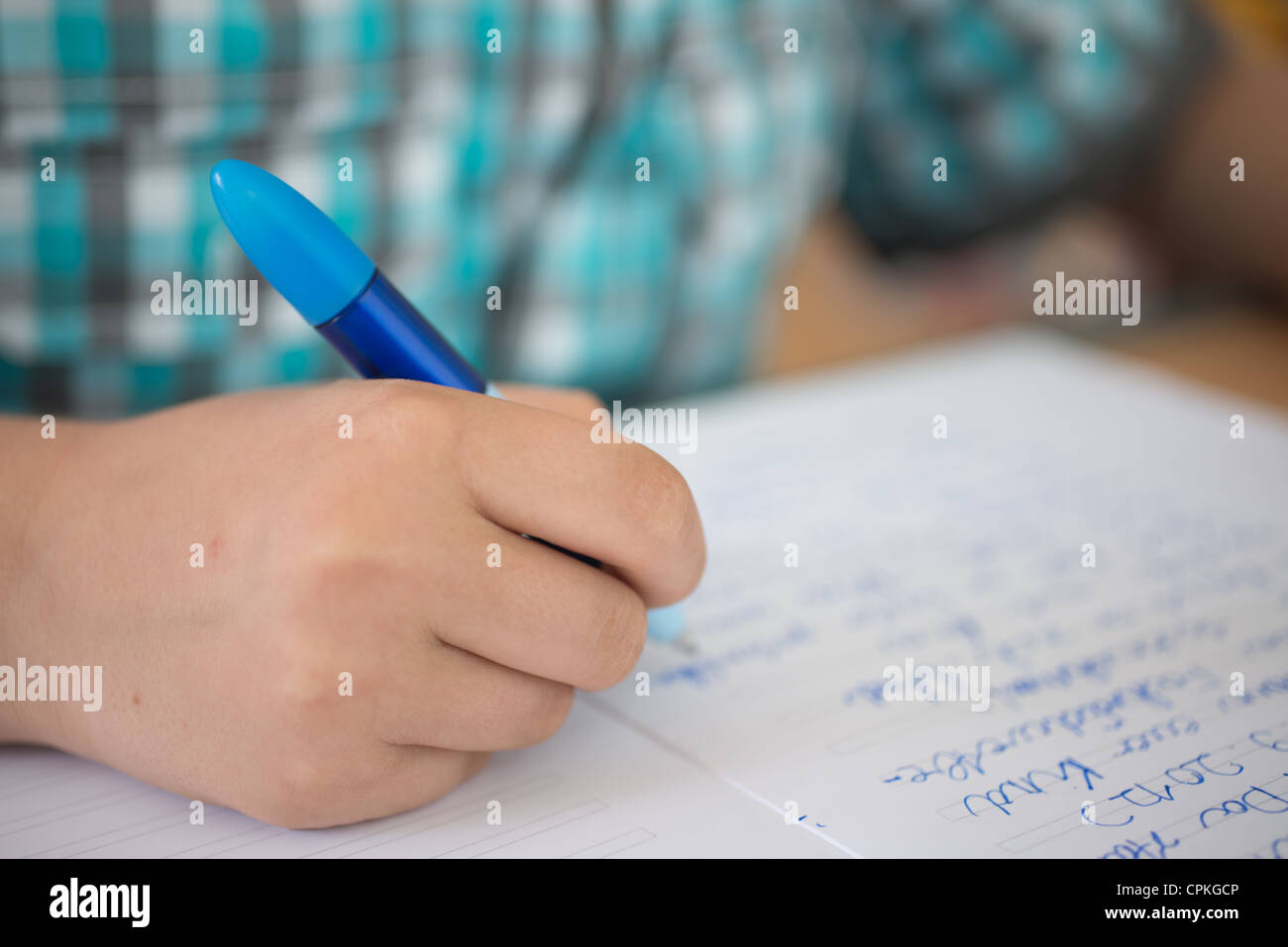 Young boy, 7 years old, writing and doing his homework Stock Photo - Alamy