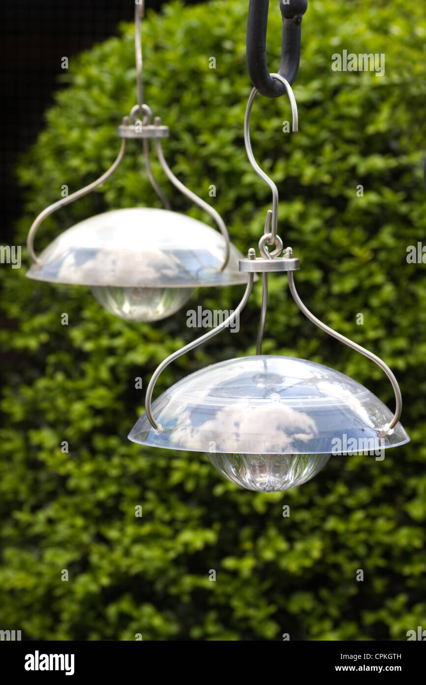 Decorative hanging solar lamps with reflection of clouds in sky to ...