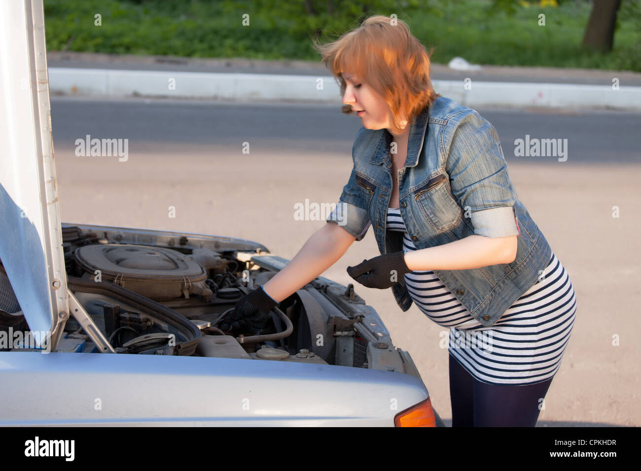 Pregnant Woman Trying to Repair the Car Stock Photo - Alamy