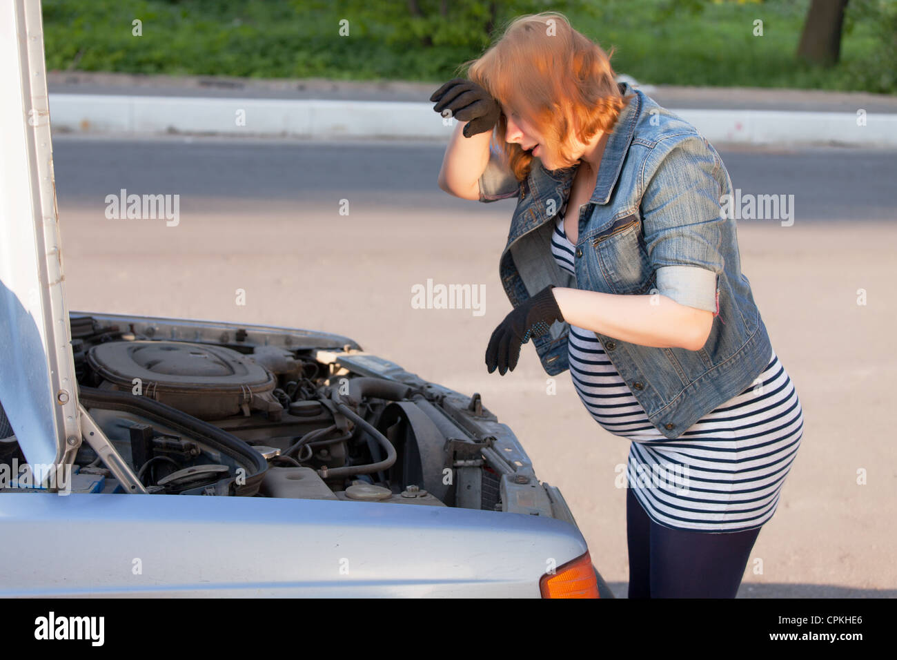 Pregnant Woman Trying to Repair the Car Stock Photo - Alamy