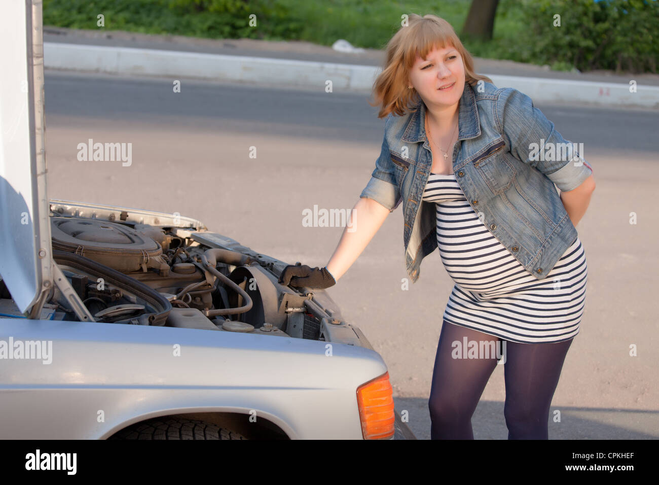 Pregnant Woman Trying to Repair the Car Stock Photo - Alamy