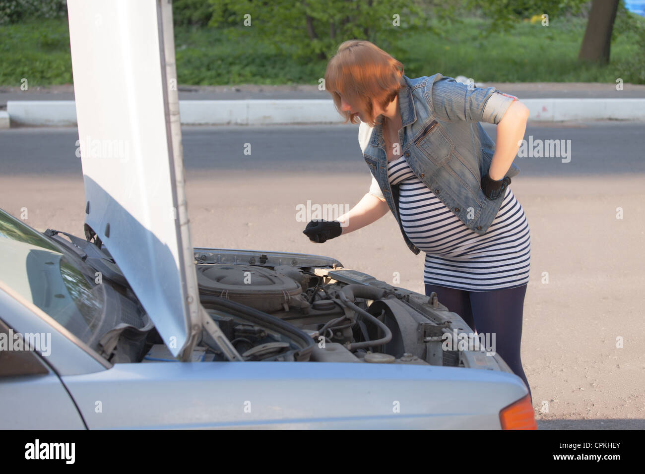 Pregnant Woman Trying to Repair the Car Stock Photo - Alamy
