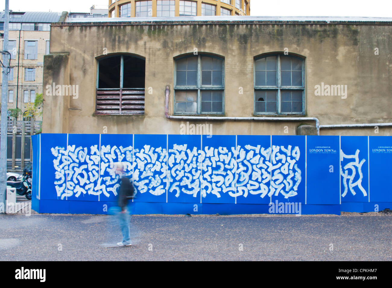 A man walking past graffiti in south bank, London Stock Photo - Alamy