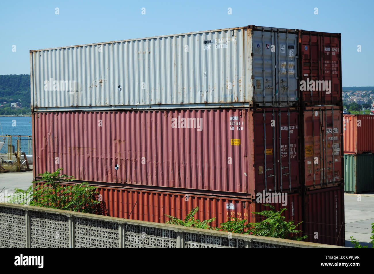 Stacked containers at harbour Stock Photo - Alamy