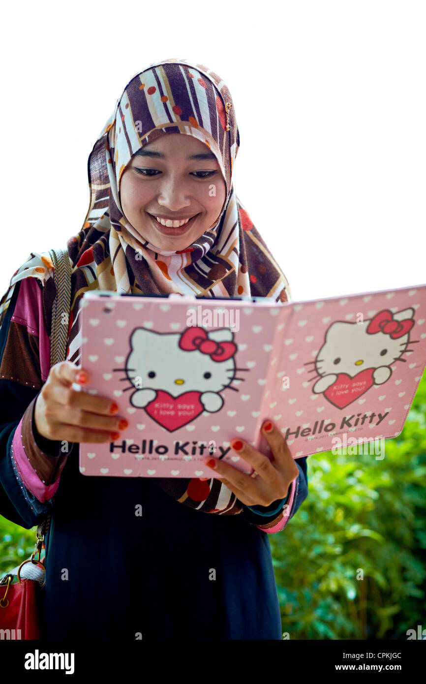 Muslim girl with decorative Hello Kitty iPad cover Stock Photo - Alamy