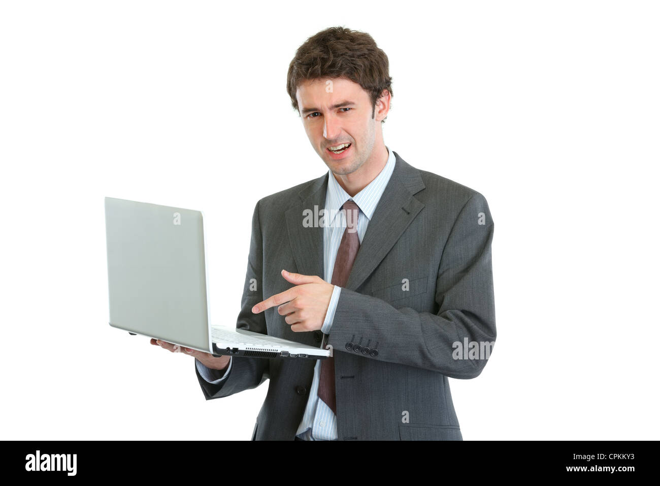 Angry businessman pointing in laptop Stock Photo - Alamy
