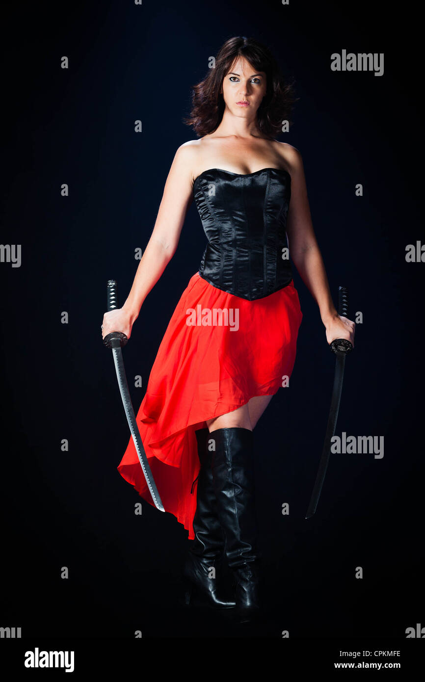 Female assassin in red skirt displays her power Stock Photo - Alamy