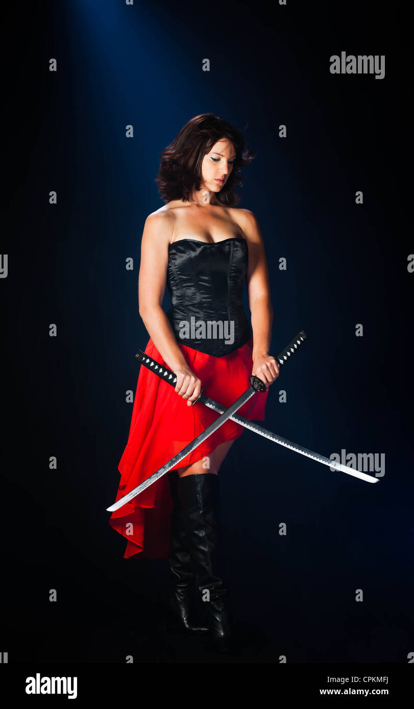 Female assassin in red skirt displays her power Stock Photo - Alamy