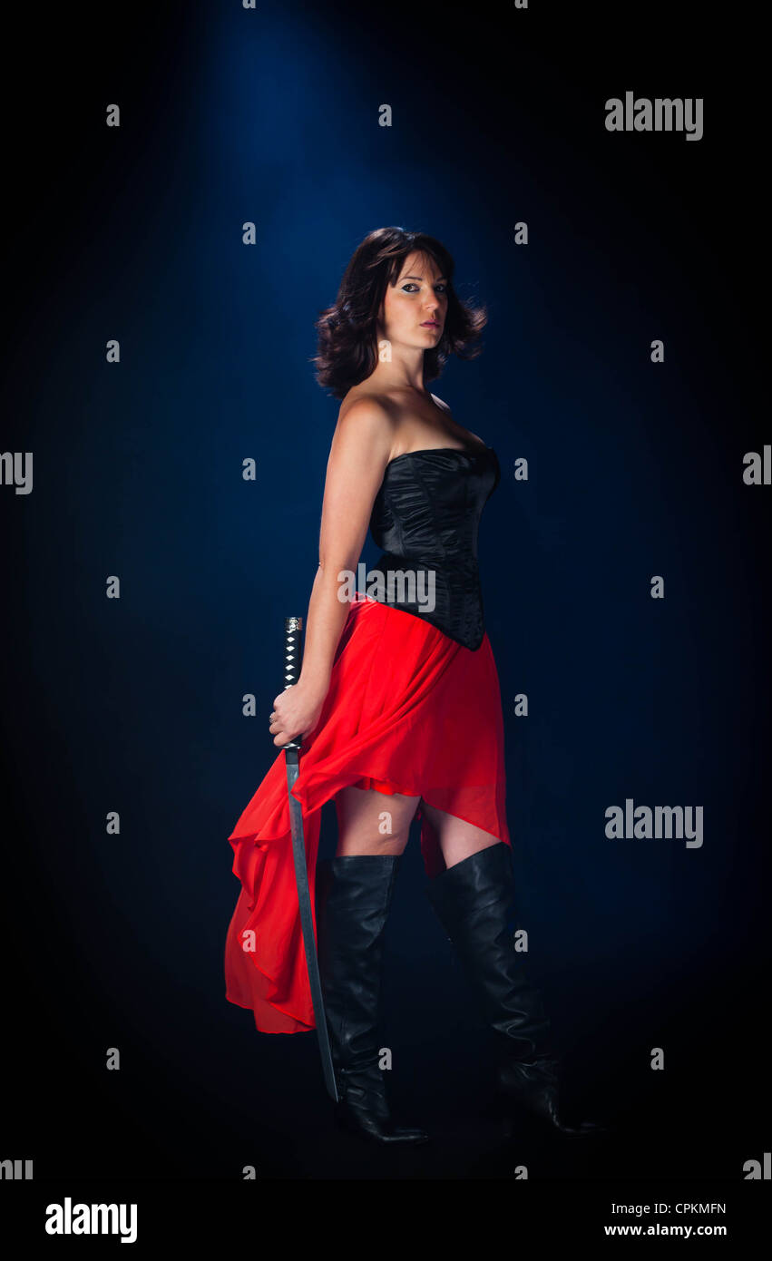 Female assassin in red skirt displays her power Stock Photo - Alamy