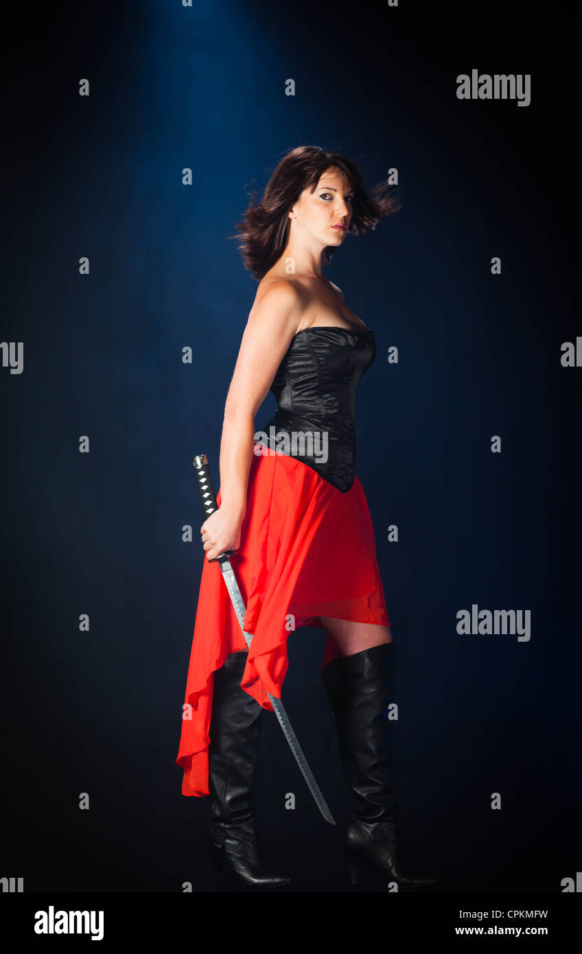 Female assassin in red skirt displays her power Stock Photo - Alamy