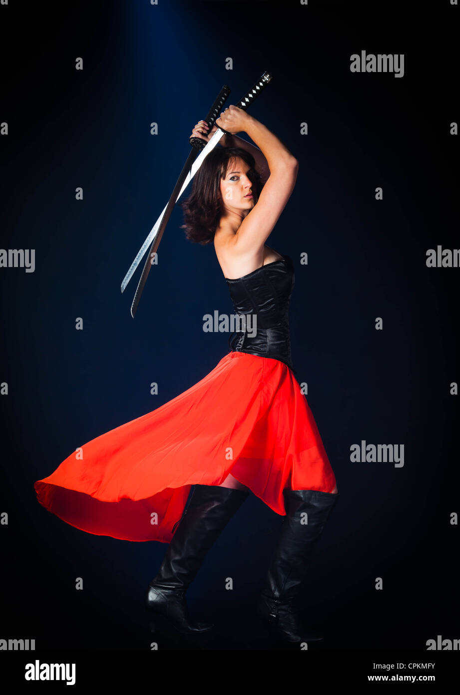 Female assassin in red skirt displays her power Stock Photo - Alamy