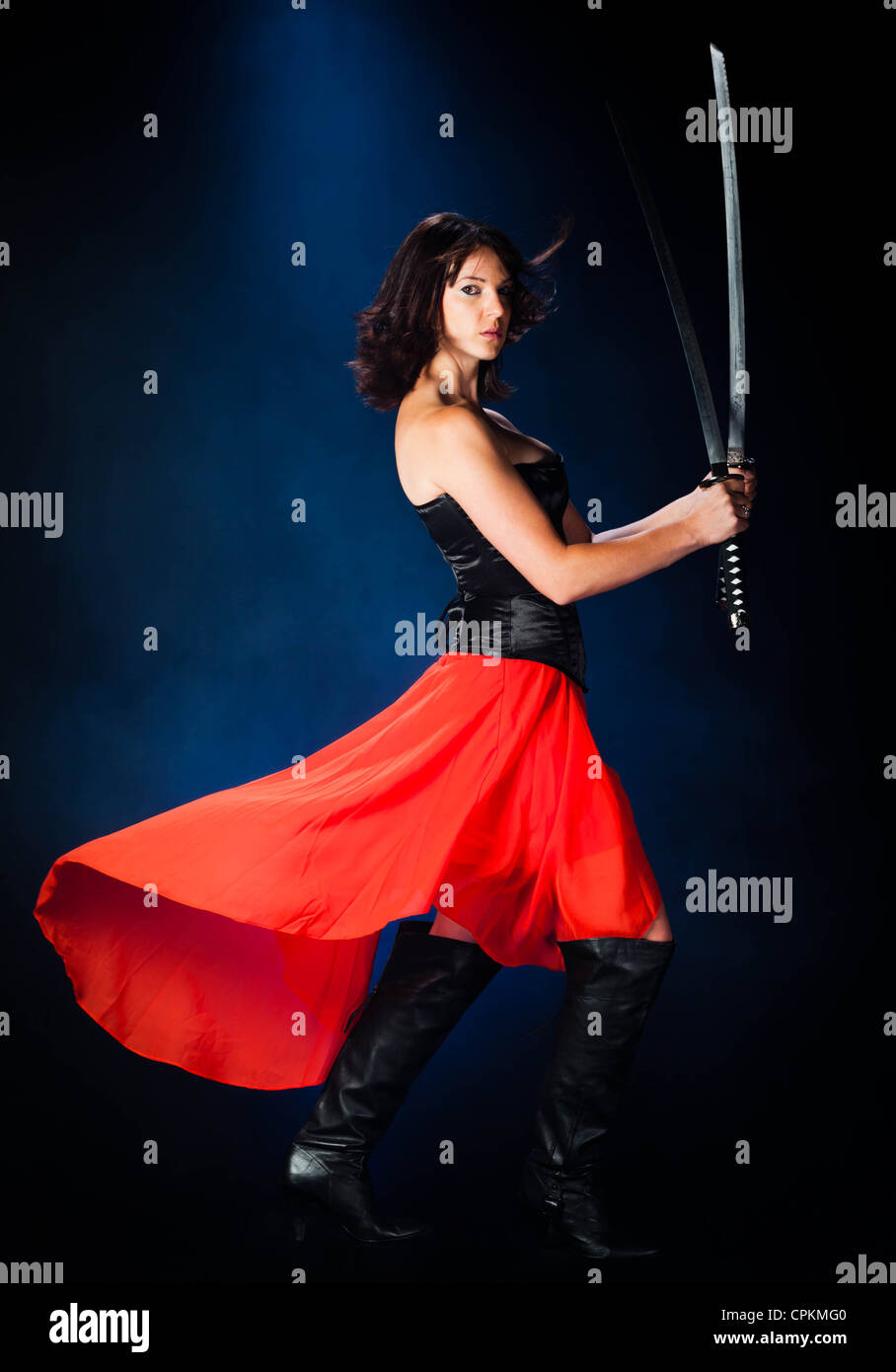 Female assassin in red skirt displays her power Stock Photo - Alamy