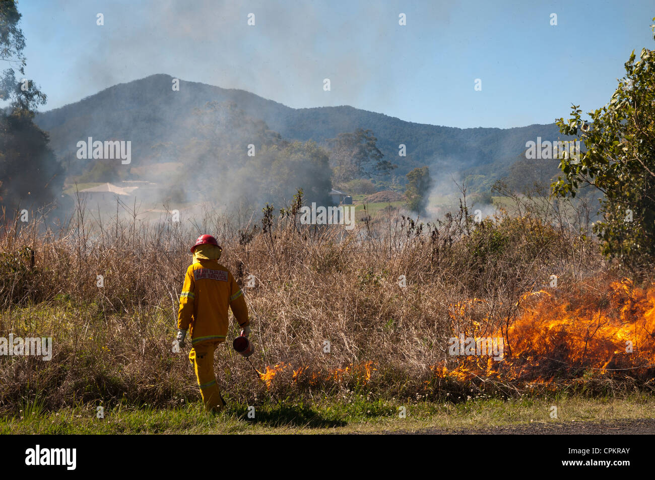 Fireman lighting fire as part of a controlled burn off Stock Photo - Alamy