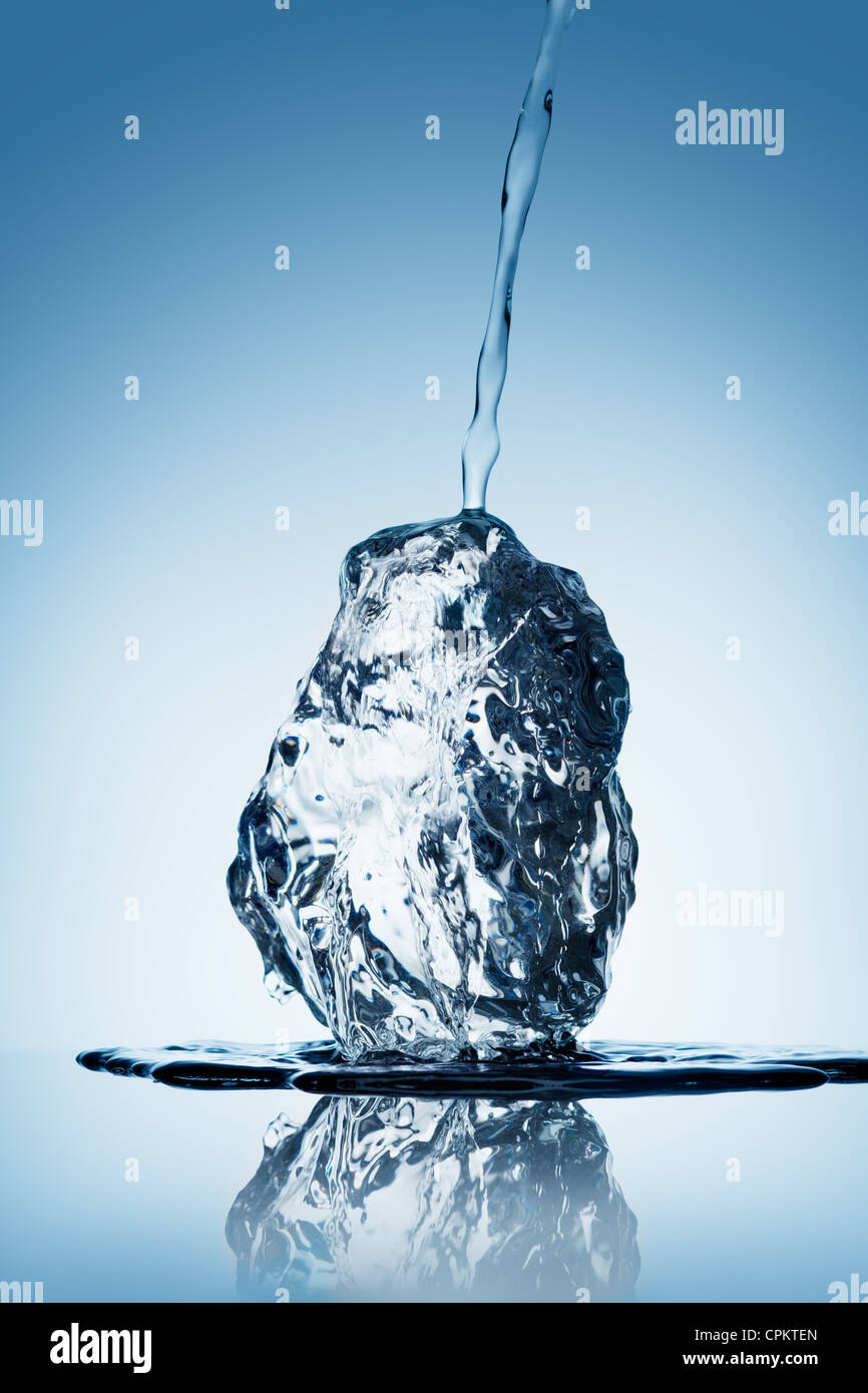 Water pouring on ice Stock Photo - Alamy