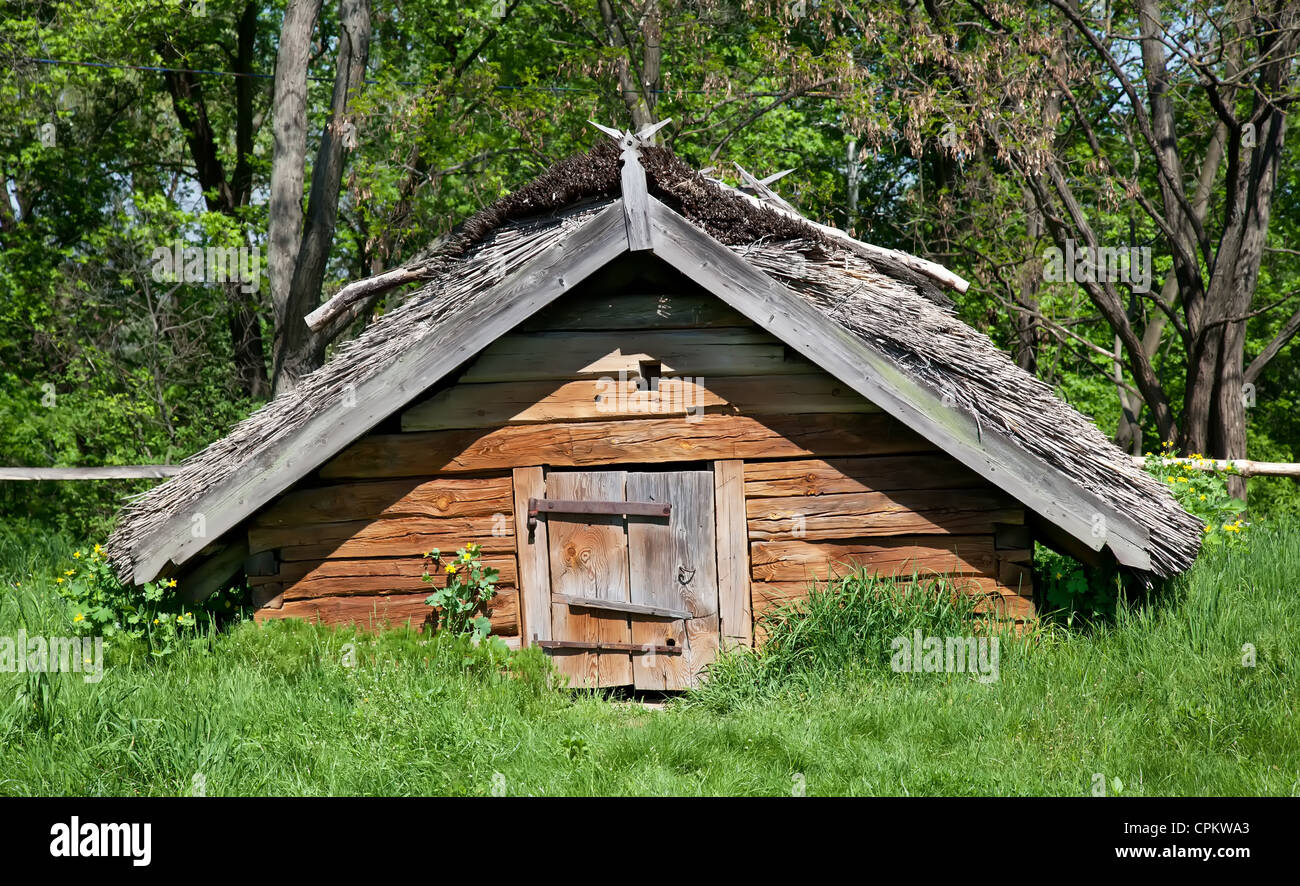 Ancient wooden cottage in meadow Stock Photo - Alamy