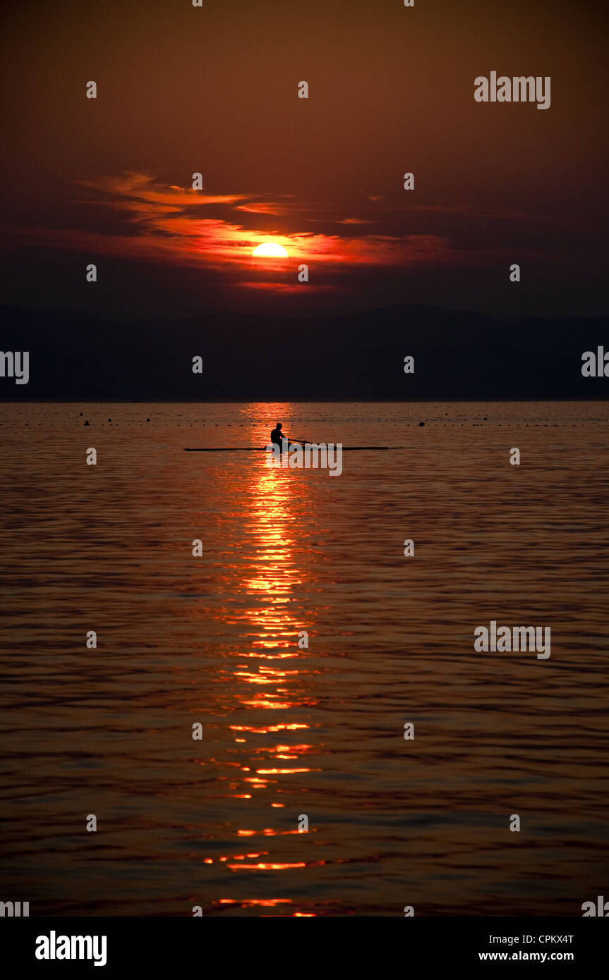a person rowing during sunset Stock Photo - Alamy