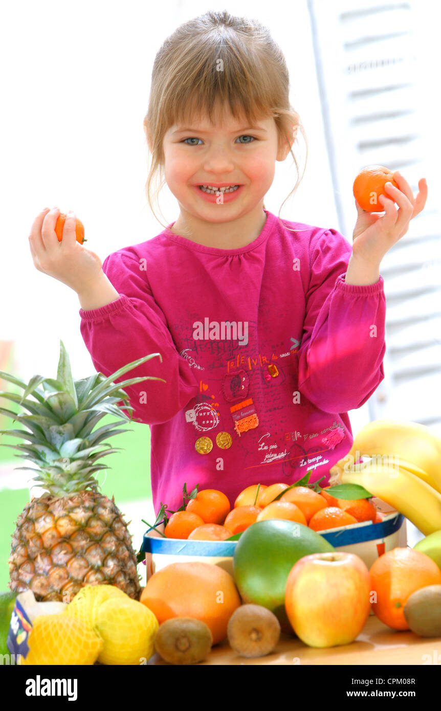 CHILD EATING FRUIT Stock Photo - Alamy