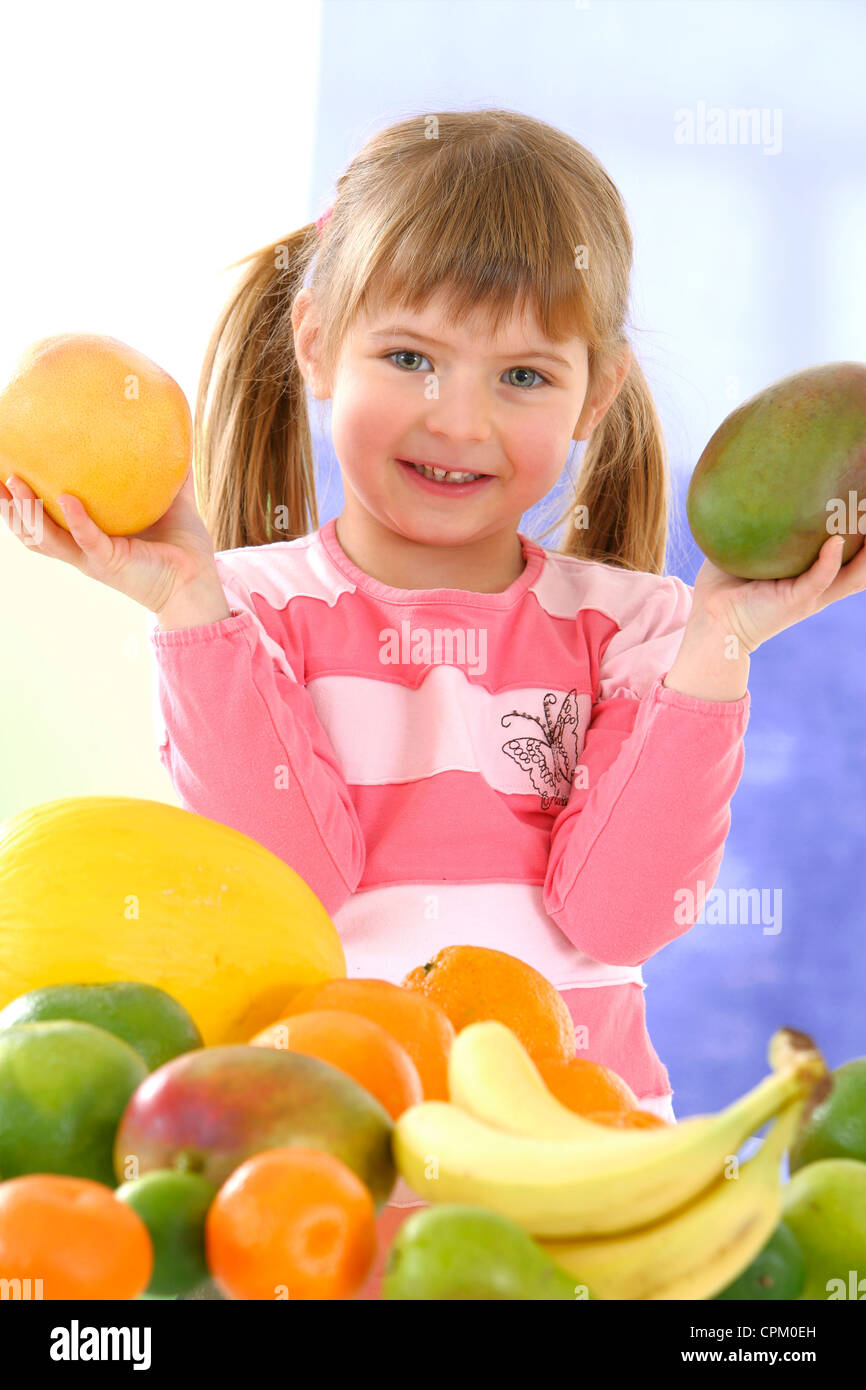 CHILD EATING FRUIT Stock Photo - Alamy