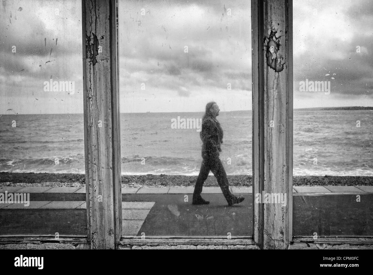 Man walking past window Black and White Stock Photos & Images - Alamy
