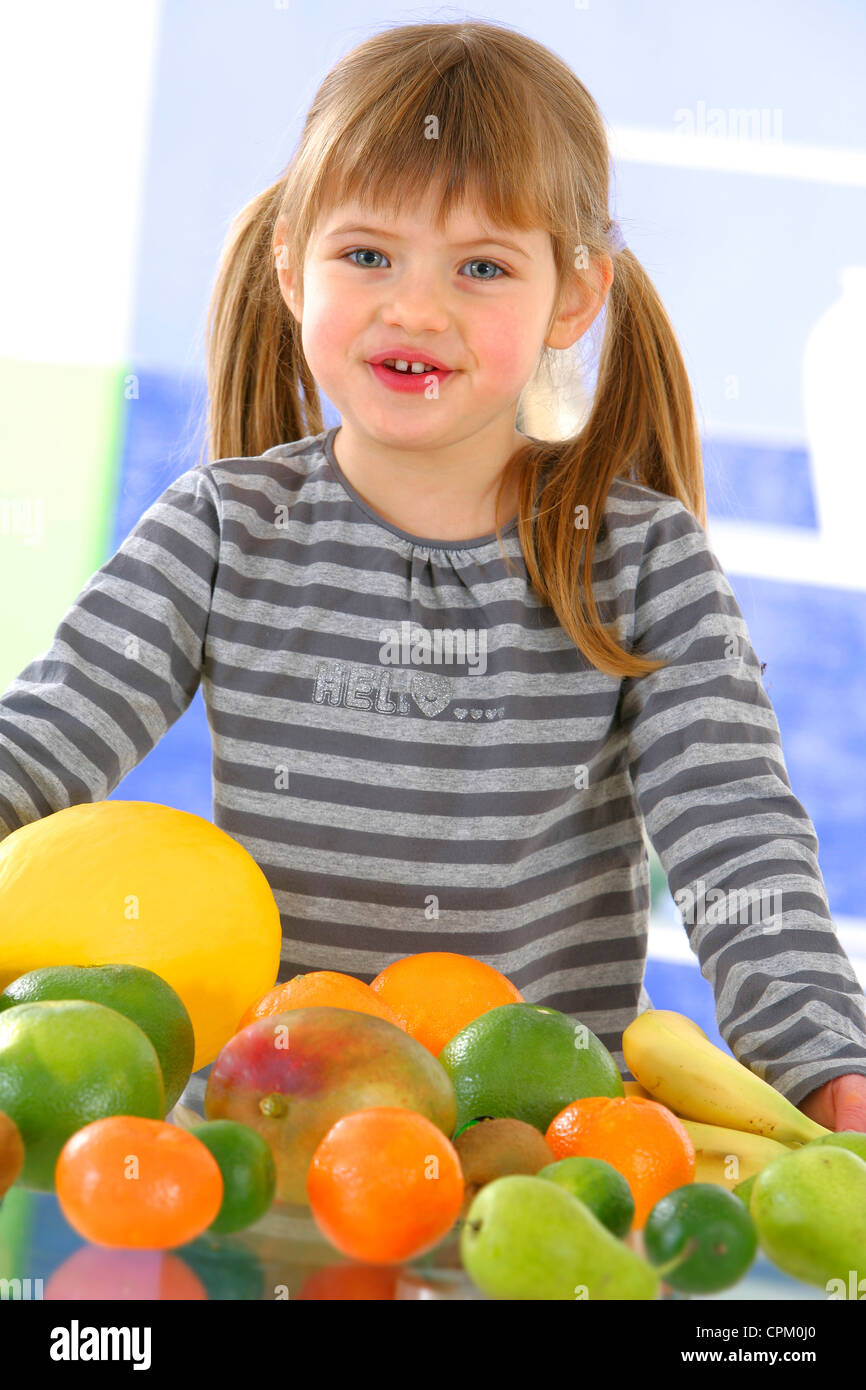 CHILD EATING FRUIT Stock Photo - Alamy