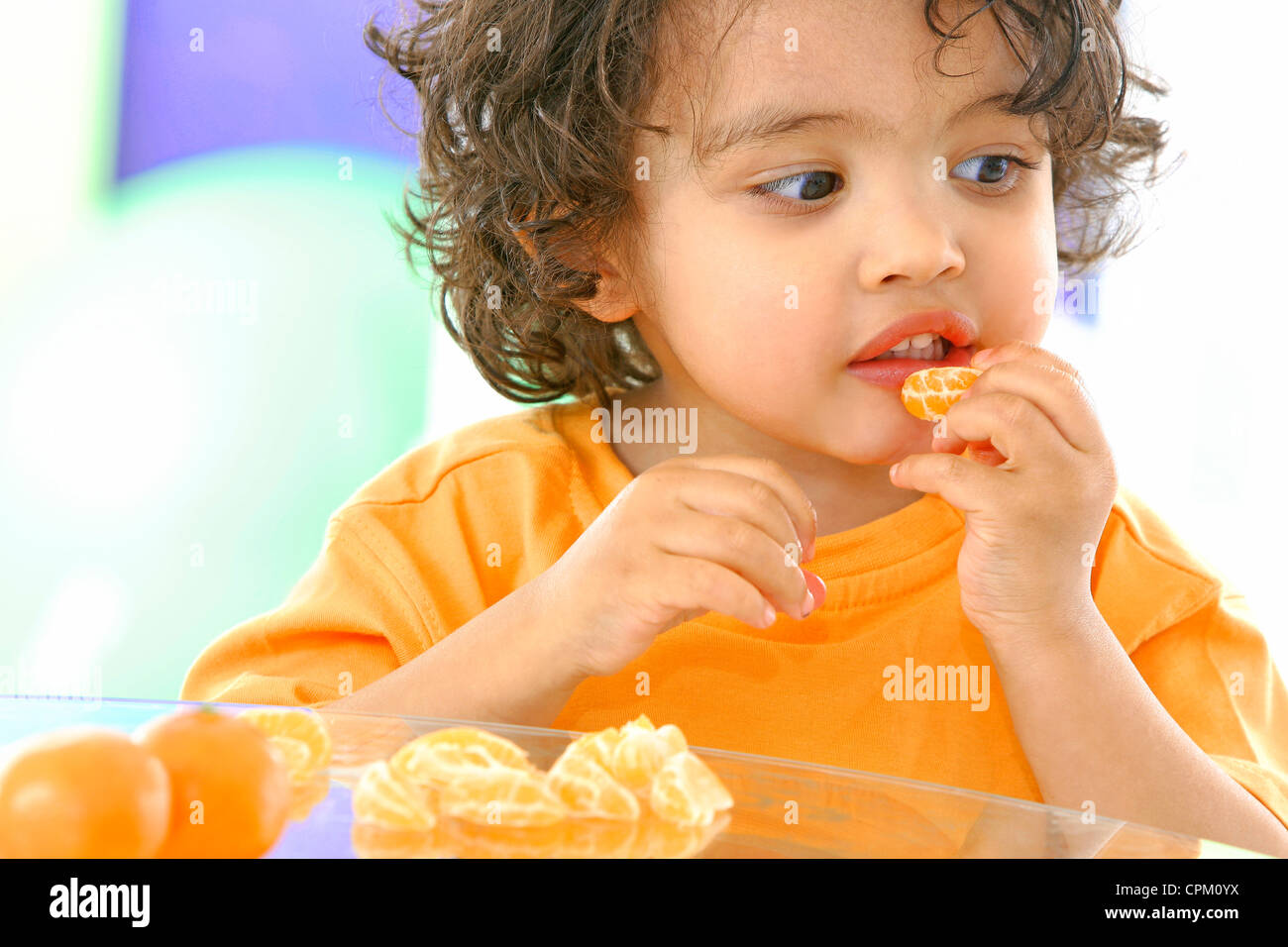 CHILD EATING FRUIT Stock Photo - Alamy