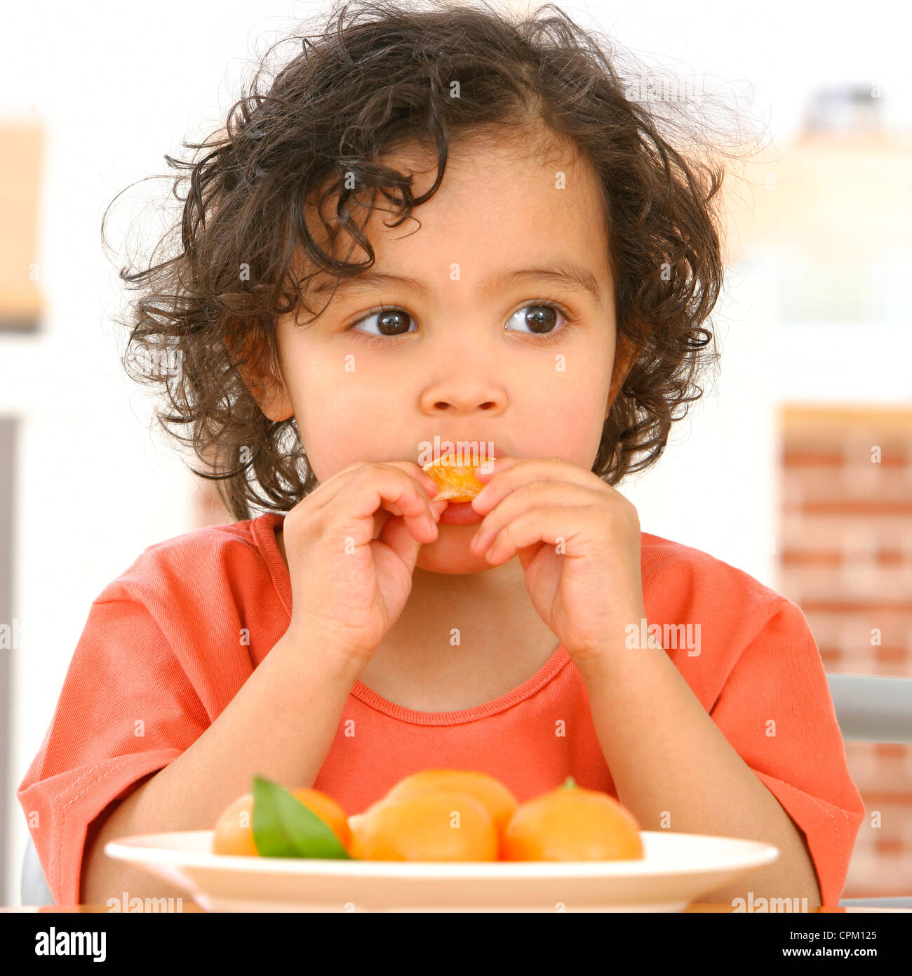 CHILD EATING FRUIT Stock Photo - Alamy