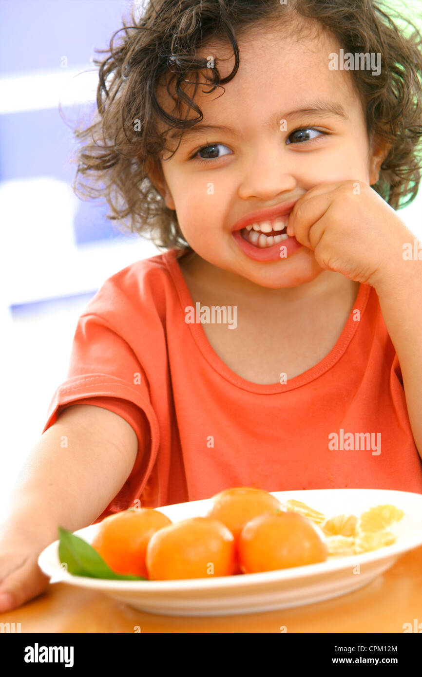 CHILD EATING FRUIT Stock Photo - Alamy
