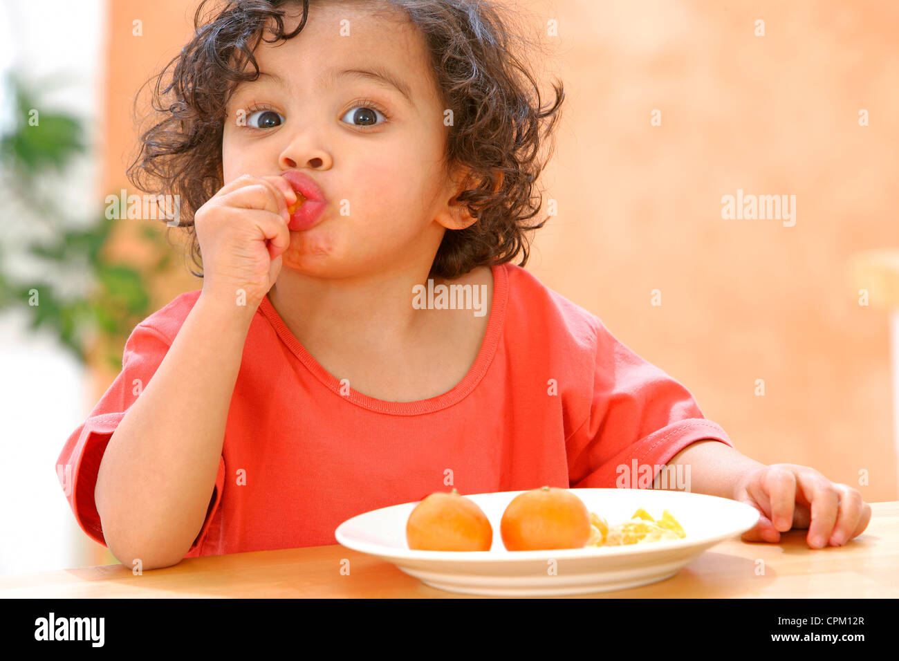 CHILD EATING FRUIT Stock Photo - Alamy