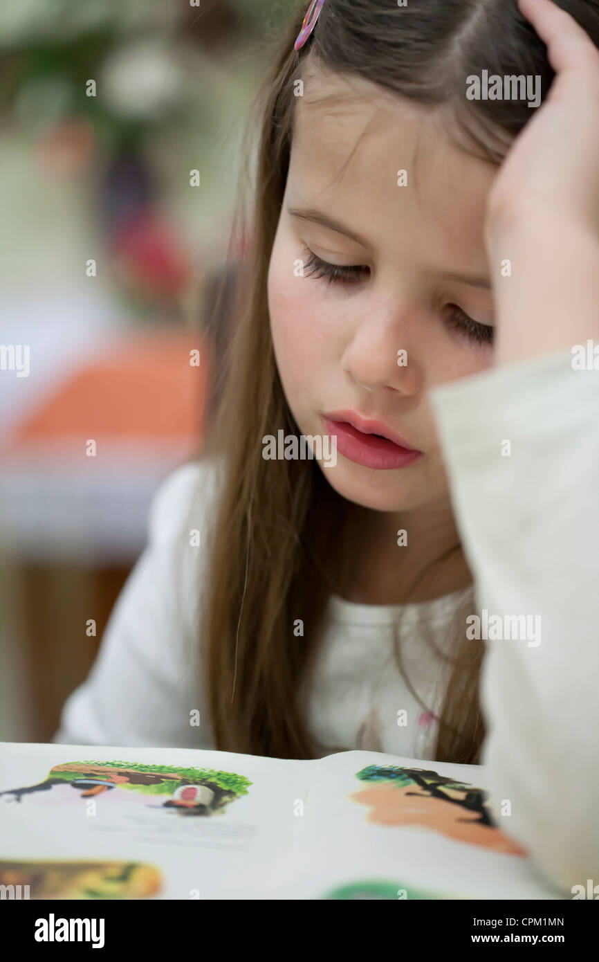 Girl reading book of fairy tales Stock Photo - Alamy